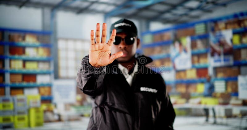Security Guard in Warehouse Making Stop Gesture Stock Photo - Image of ...