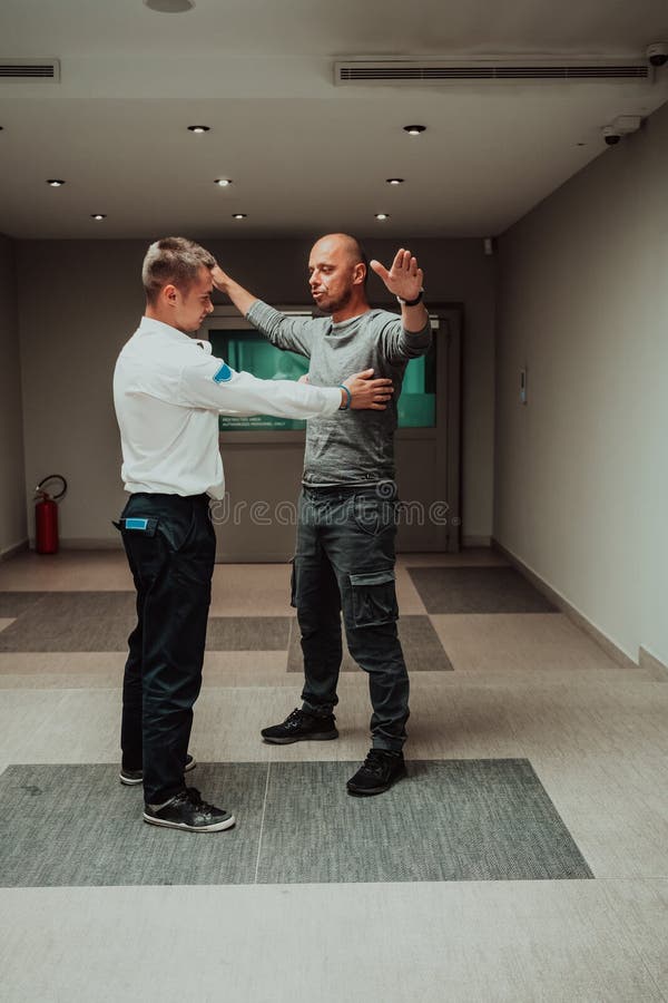 Security Guard Making Body Searching Procedure on Man for Finding ...