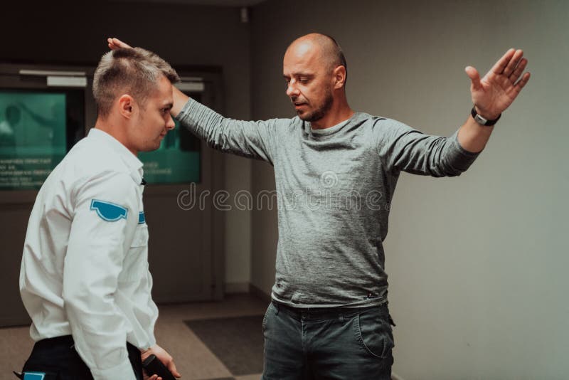 Security Guard Making Body Searching Procedure on Man for Finding ...