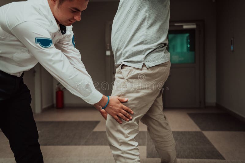 Security Guard Making Body Searching Procedure on Man for Finding ...