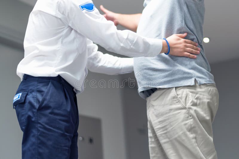 Security Guard Making a Pat-down Procedure for Finding Hidden Objects ...
