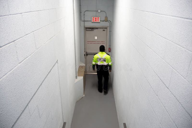 A Security Guard is Patrolling an Office at Night. Stock Photo - Image ...