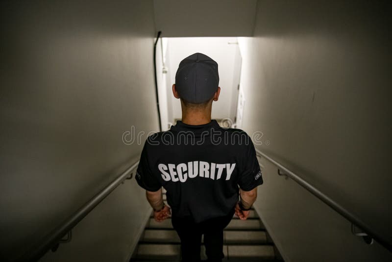 Security Guard Patrolling on Stairs Inside Commercial Building Stock ...