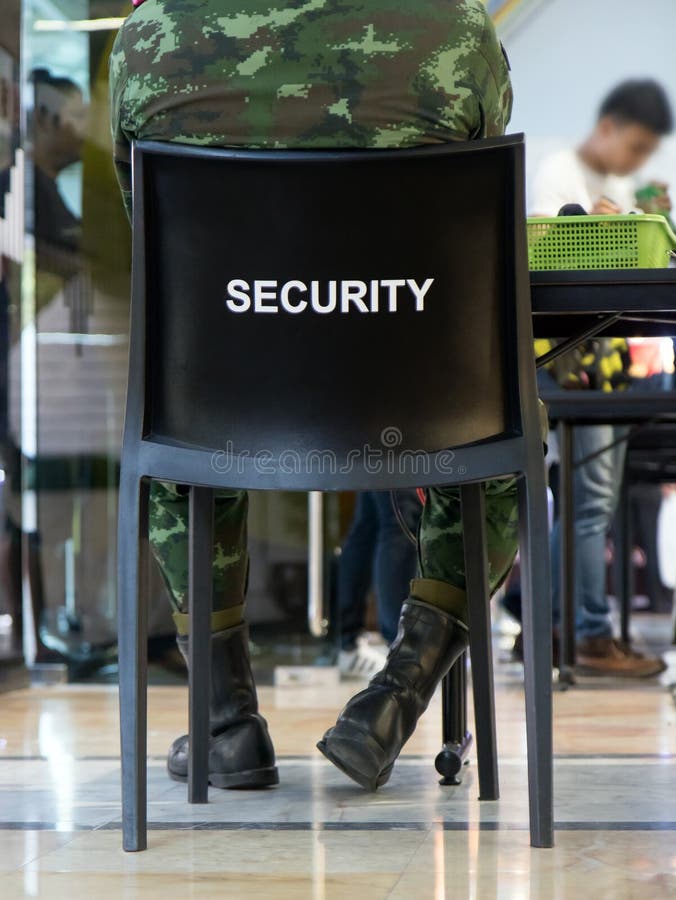 Security Guard Sitting on a Chair Stock Photo - Image of control ...