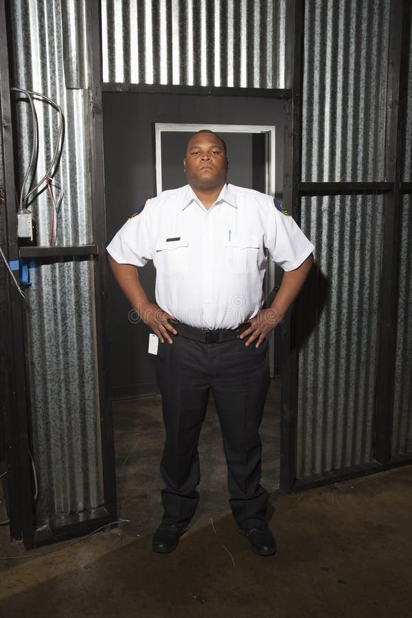Security Guard Standing at Corrugated Metal Doorway Stock Image - Image ...
