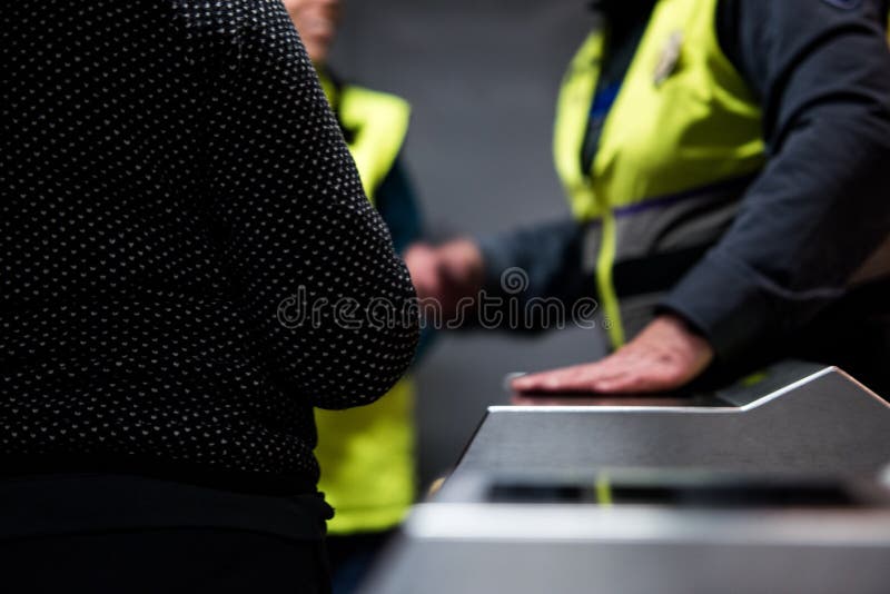 Security Guard in Subway Station. Guard Checking an Automatic Ticket ...