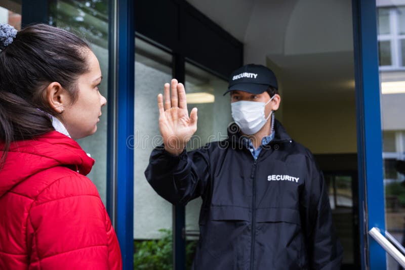 Security Guard Making Stop Hand Gesture To Woman Stock Photo - Image of ...
