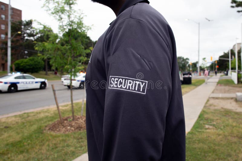 Security Guard in Uniform Patrolling a Residential Area. Stock Image ...