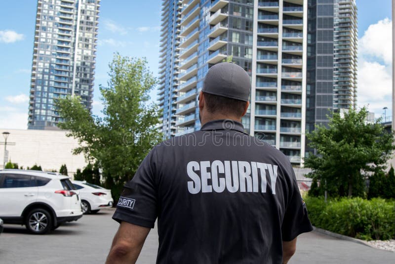 Security Guard in Uniform Patrolling a Residential Area. Stock Image ...