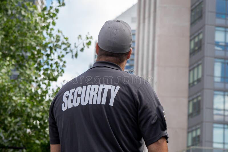 Security Guard in Uniform Patrolling a Residential Area. Stock Photo ...