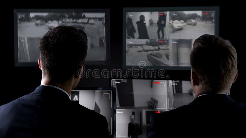 Security Guards Watching Surveillance Cameras, Guarding Important ...