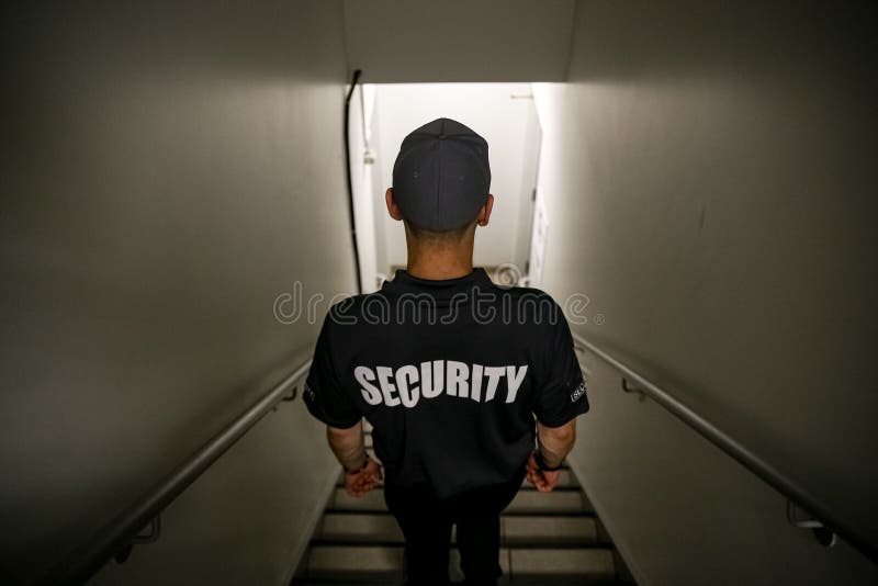 Security Guy with a Black Hat and a Uniform Walking Down the Stairs ...