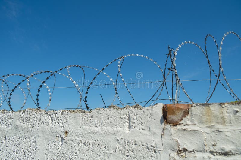 Security Measure on Brick Wall Using Razor Wire Stock Photo - Image of ...