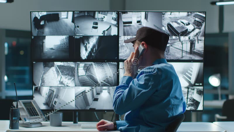 Security Officer Watching Cctv Video Screens and Talking on Radio Stock ...