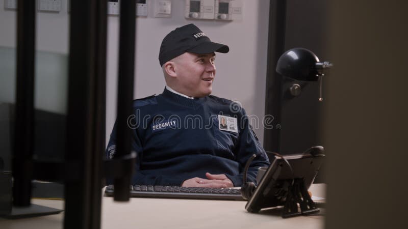 Security Officer Sits by Table, Smiles and Discuss Work Process Stock ...