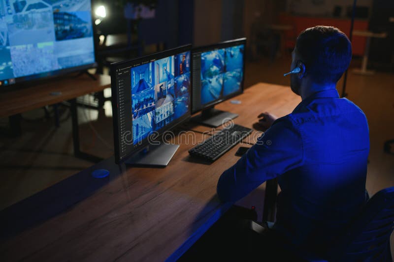 Security Operator Controls CCTV Cameras in Office at Night. Modern ...