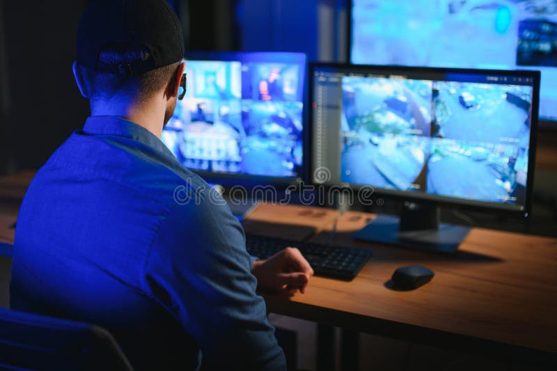 Security Operator Controls CCTV Cameras in Office at Night. Modern ...