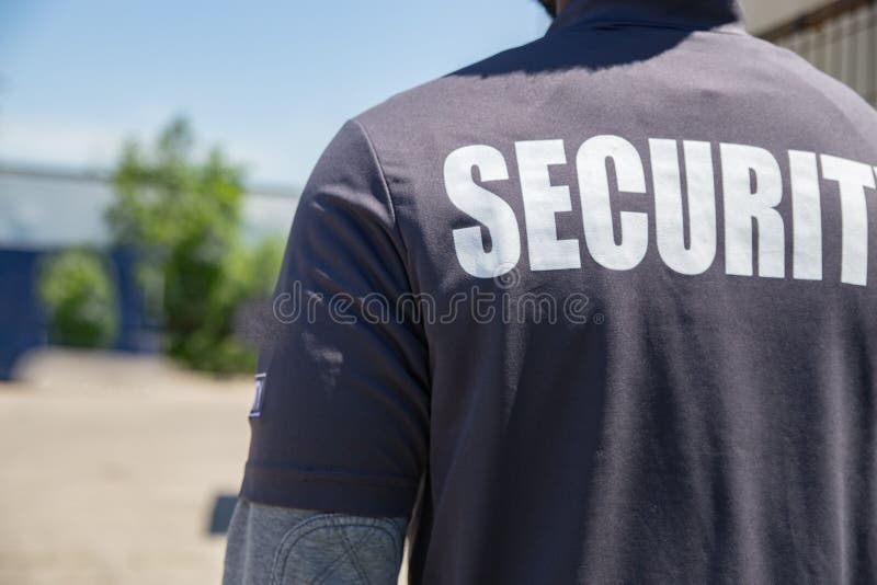Security Person Standing Outdoors in the Sun, Shot from Back Stock ...