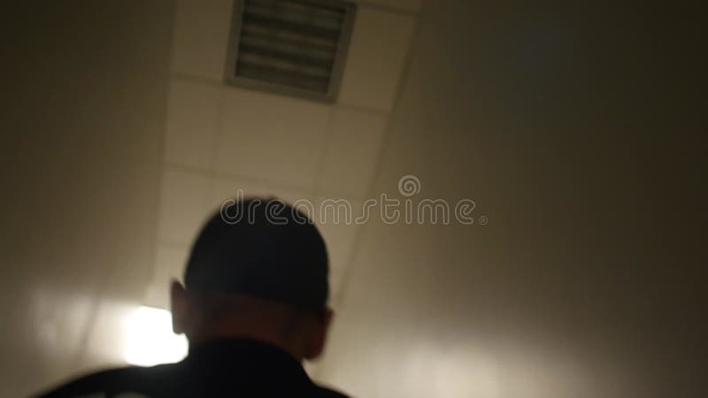 Security Person Walking in the Corridor - Shot from the Back Stock ...