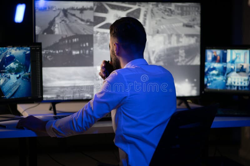 Security System CCTV Monitor Room. Man Using Walkie Talkie Stock Photo ...