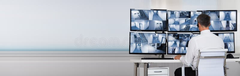 Security System Operator Looking at CCTV Camera Footage Stock Photo ...