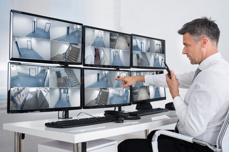 Security System Operator Looking at CCTV Footage Stock Image - Image of ...