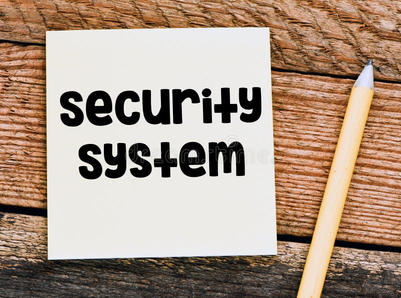 SECURITY SYSTEM Words Written on a Piece of Paper and a Wooden Table ...