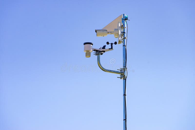 Security Video Camera and Wind Indicator Against Sky Stock Image ...