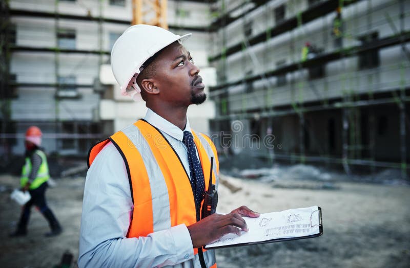 See Beyond the Brick. a Young Man Going Over Building Plans at a ...
