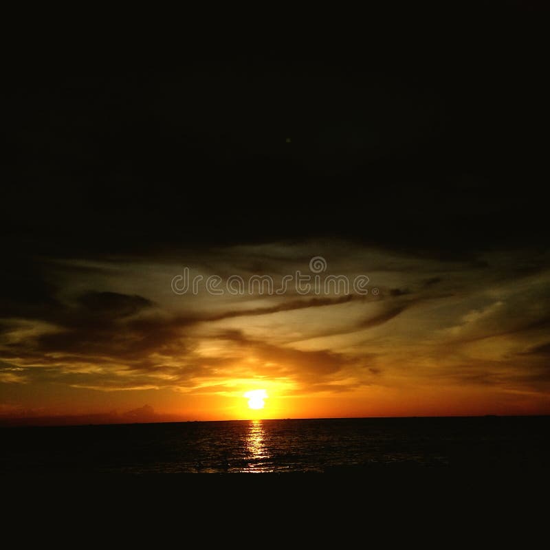 See the Sun Sinking into the Sea Stock Photo - Image of dusk, night ...