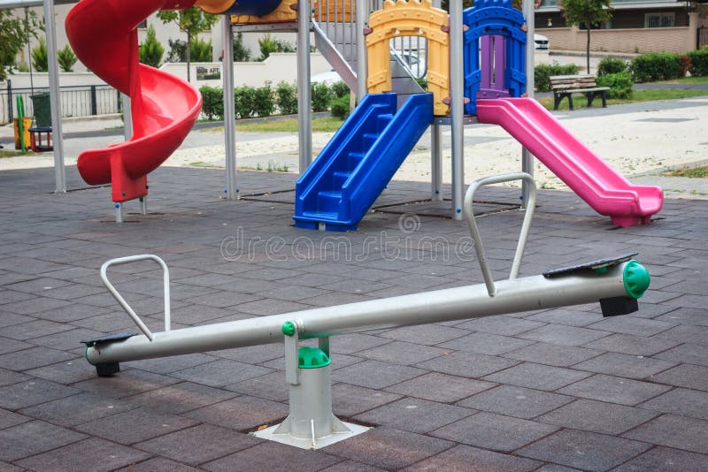 Seesaw and Slides in Colorful Playground Stock Photo - Image of ...