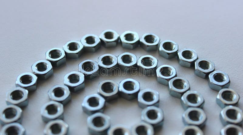 Segment of Round Pattern Made with Same Diameter Shiny Steel Nuts on ...