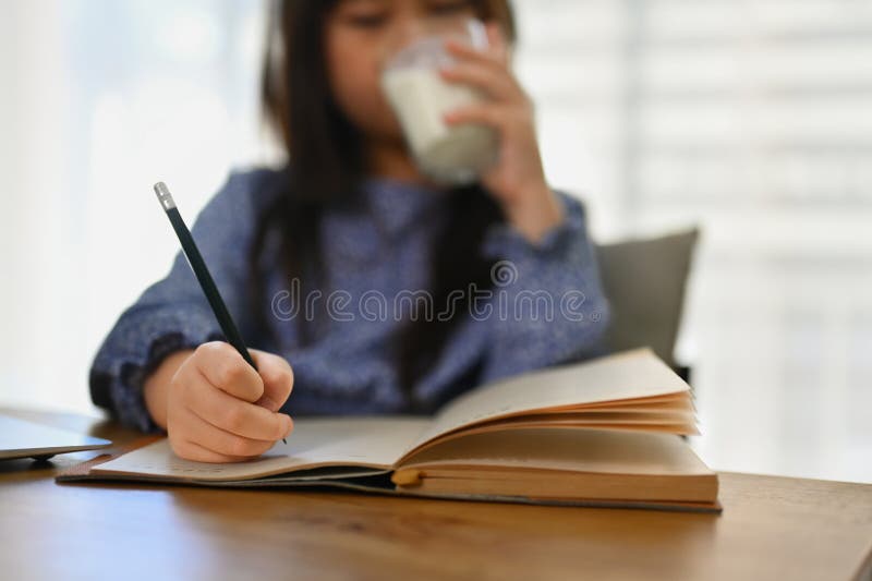 Select Focus on Hands of Asian School Girl Doing Homework at Dining ...