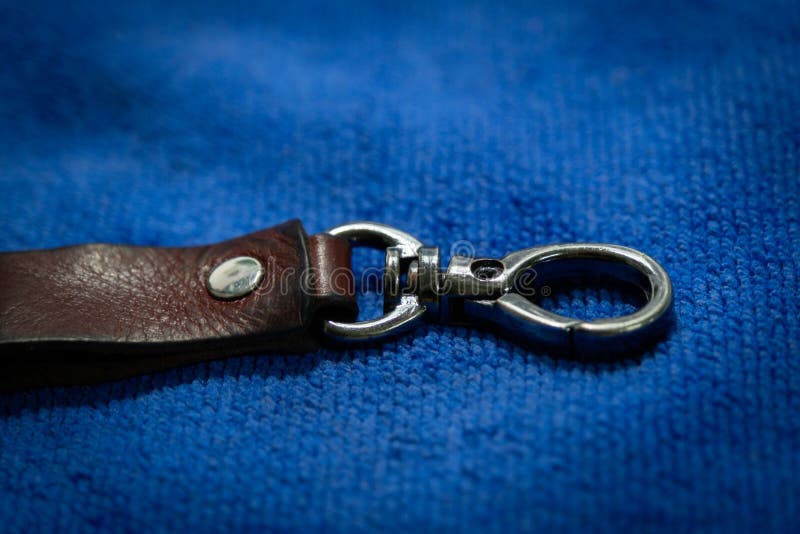 A Select Focus Leather Key Chain with Box on Blue Fabric Background ...