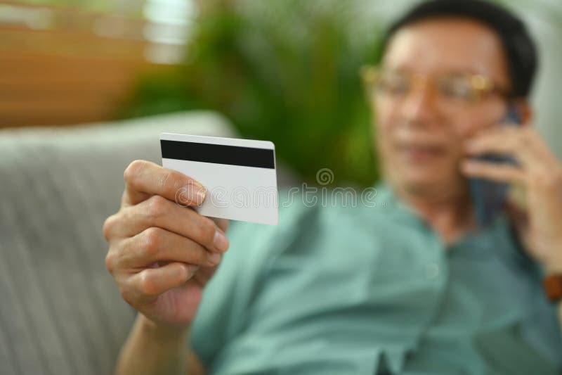 Select Focus on Senior Man Holding Bank Plastic Card and Talking on ...