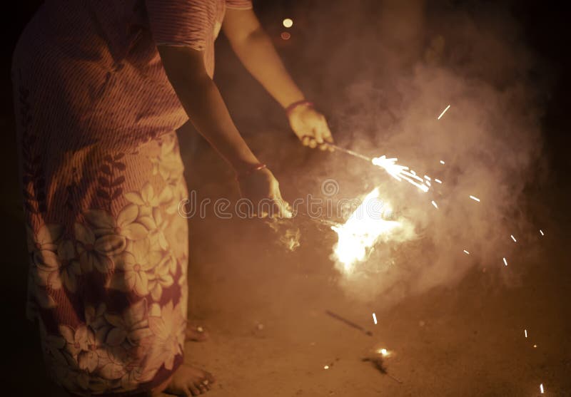 Selected Focus Shot of an Indian Woman Holding a Firecracker Stock ...