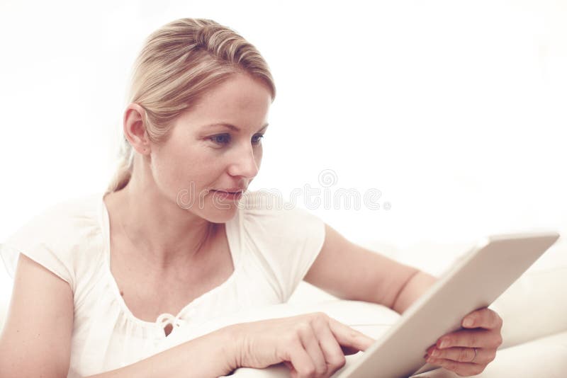 Selecting Something Good To Read - EReaders. an Attractive Blonde Woman ...