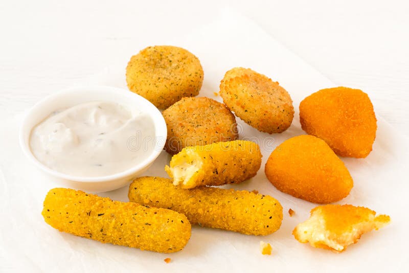 Selection of Breaded Fried Cheese on a White Baking Paper with White ...