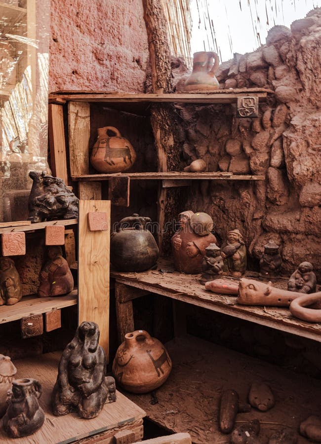 Many Different Ceramic Vessels Sitting on Shelves in a Room Filled with ...