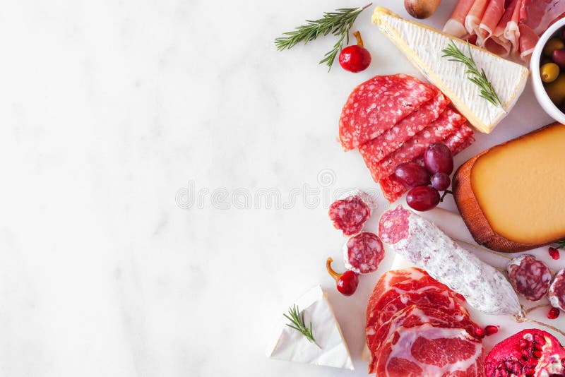 Selection of Cheese and Meat Appetizers, Side Border on a White Marble ...