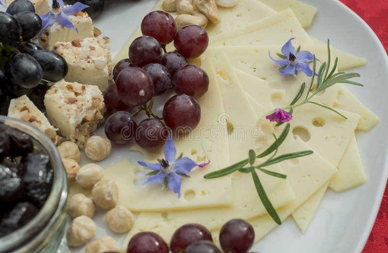 Selection of Cheeses with Grapes and Edible Flowers Stock Image - Image ...