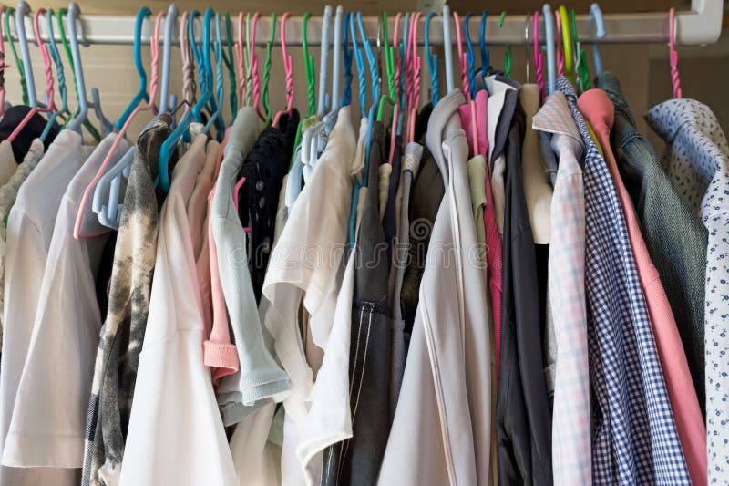 Selection of Clothes on Hangers in a Wardrobe Stock Image - Image of ...