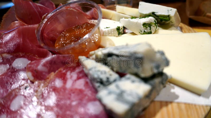 Selection of Cold Cuts and Fresh and Aged Cheeses on a Wooden Cutting ...