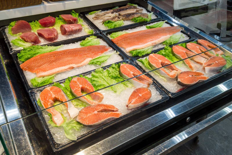 Selection of Fresh Fish Fillets and Steaks on Ice at a Seafood Counter ...