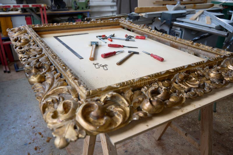Selection of Gold and Silver Tools with a Golden Frame on a Wooden ...