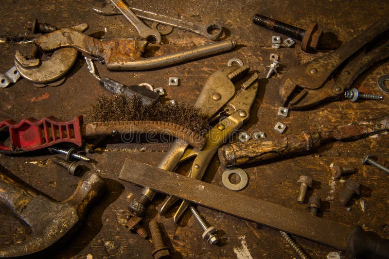 Selection of Old Worn Well Used Tools on Top of an Old Wooden Workbench ...