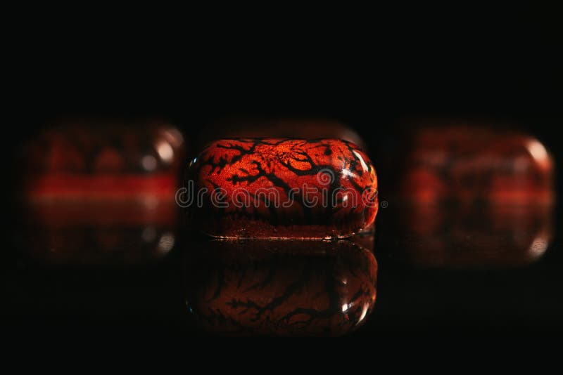 Selective Closeup of a Red Candy with Black Strips Stock Image - Image ...