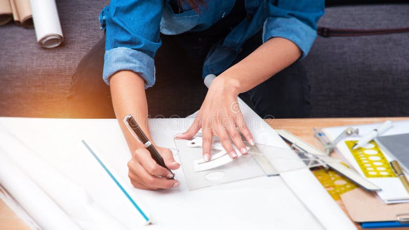 In Selective Focus of the Architect Hand is Writing on Drawing Paper ...