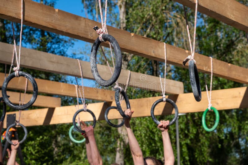 Selective Focus, Athletes Hands at a Hanging Obstacle with Metal Rings ...