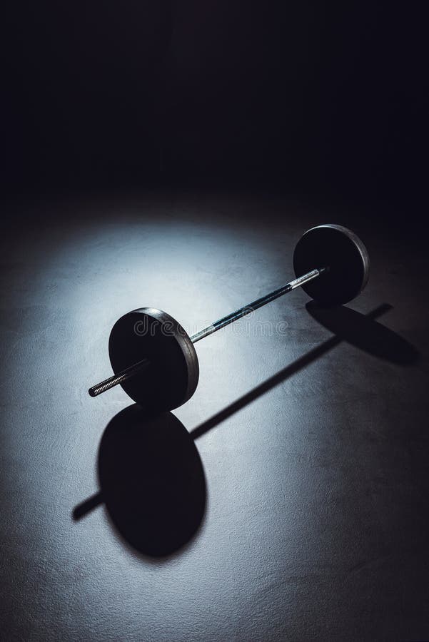 Selective Focus of Barbell on Floor with Shadow at Gym Black Stock ...